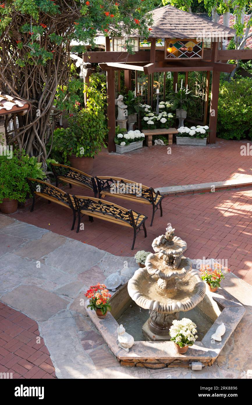 A traditional style courtyard featuring a vintage water fountain and ...