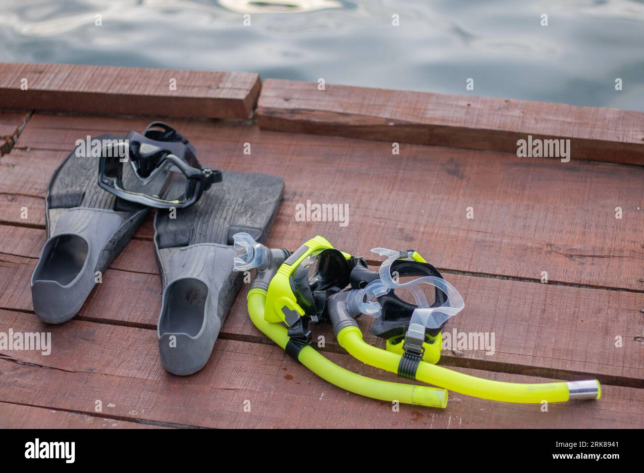 Full set of Scuba Diving equipment with selective focus on wooden pier ...