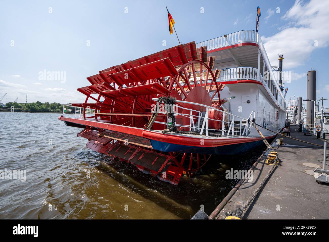 A magnificent boat is securely docked in a busy harbor with many other ...