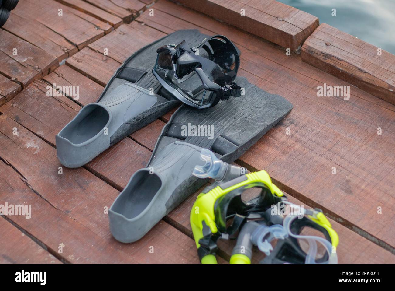 Full set of Scuba Diving equipment with selective focus on wooden pier ...