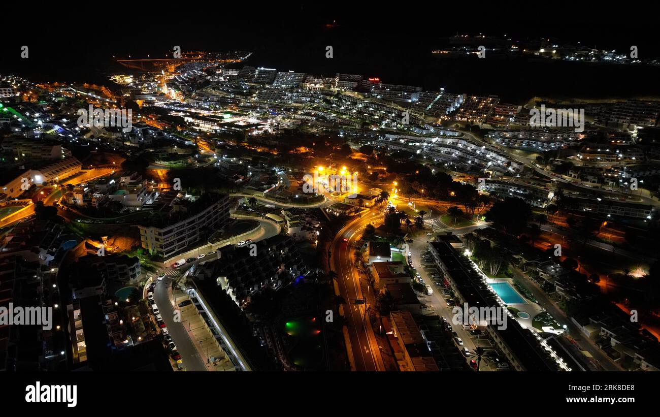 An aerial view of a stunning beachfront cityscape illuminated by bright ...