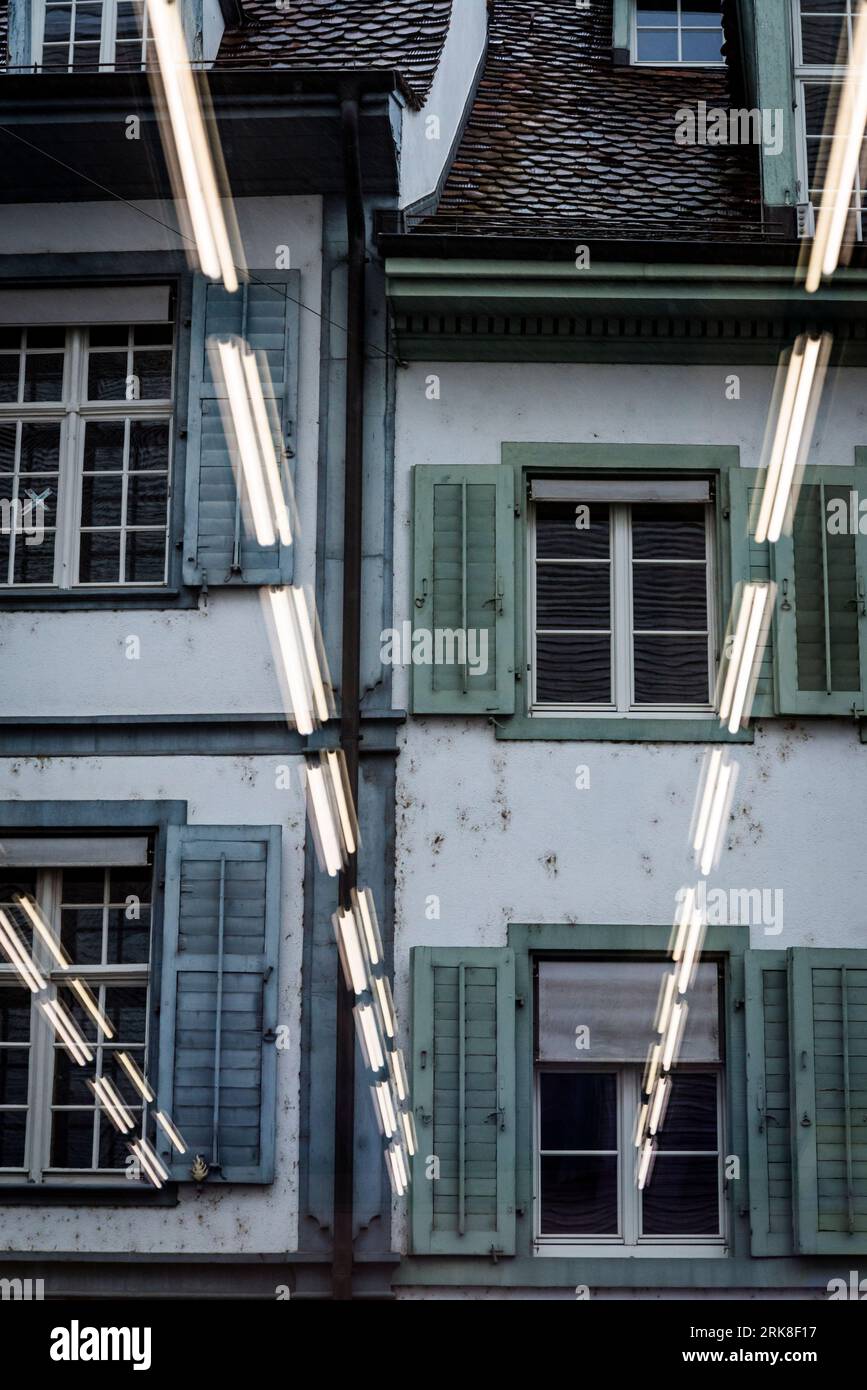 Architectural detail of historical houses seen through a glass window ...