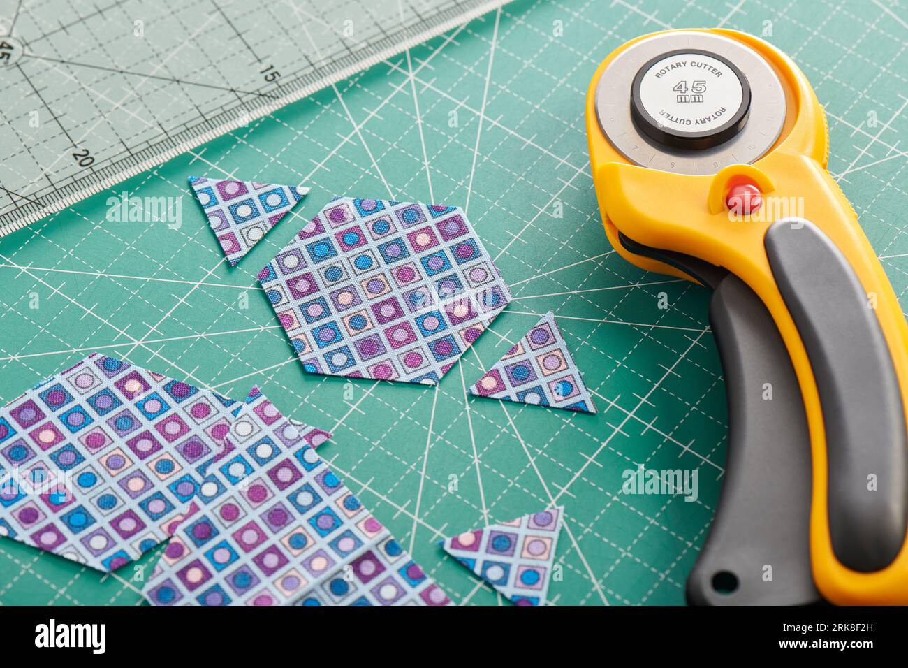 The process of cutting pieces of fabric in the shape of hexagons to ...
