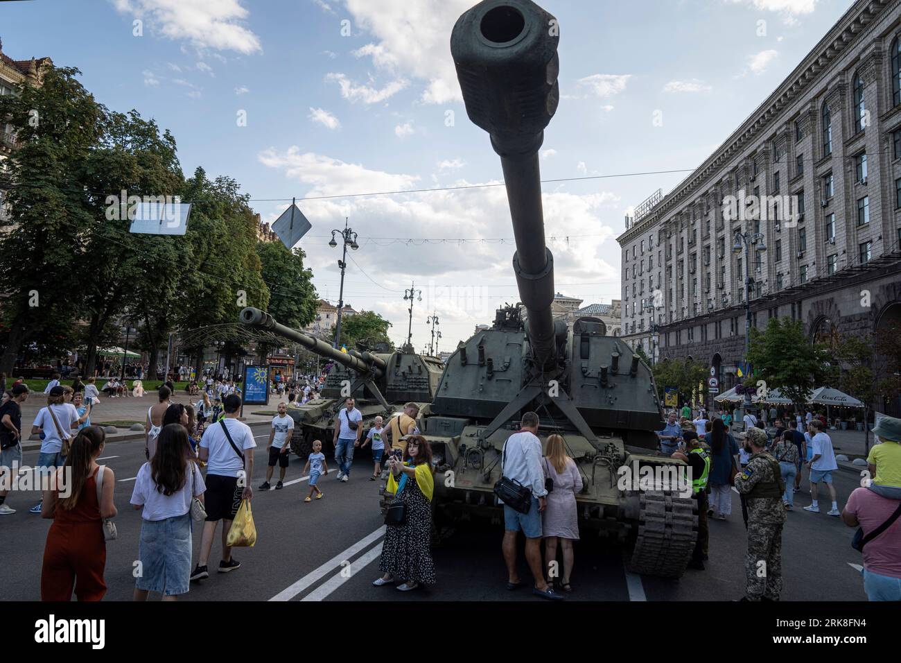 People walk in front of destroyed Russian artillery vehicles 2s19 ...