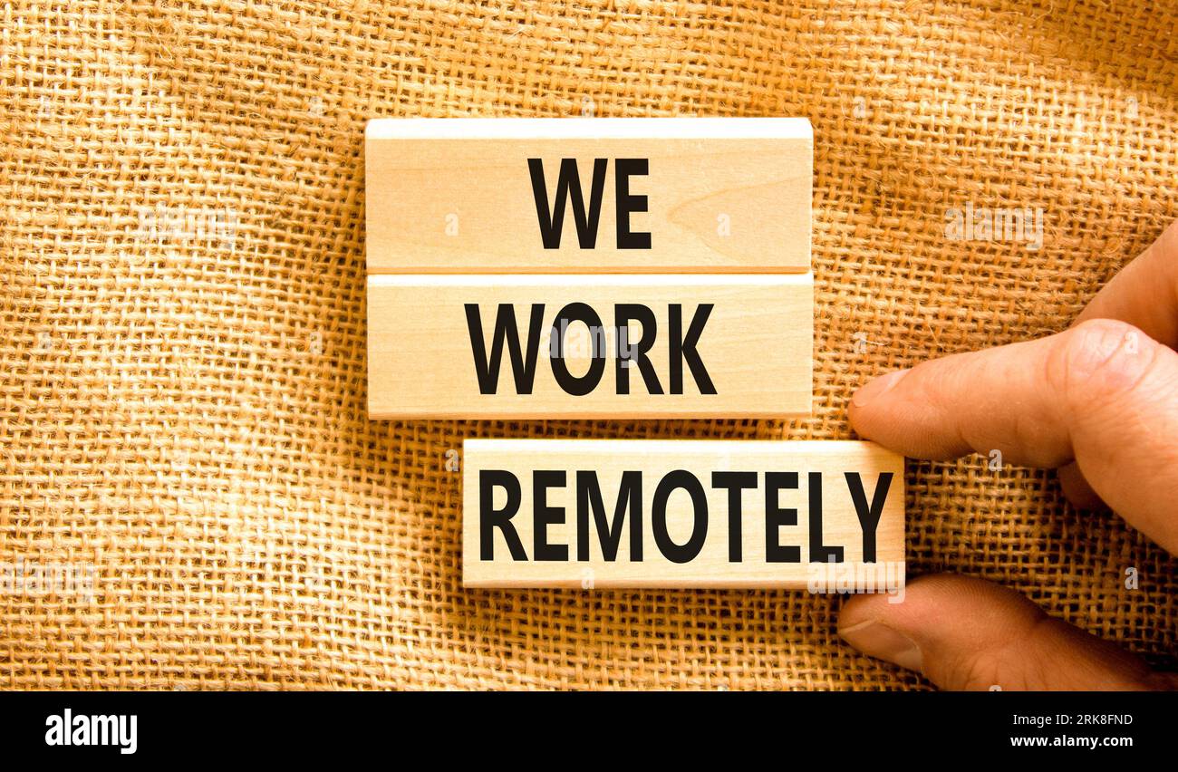 We work remotely symbol. Concept words We work remotely on wooden block ...