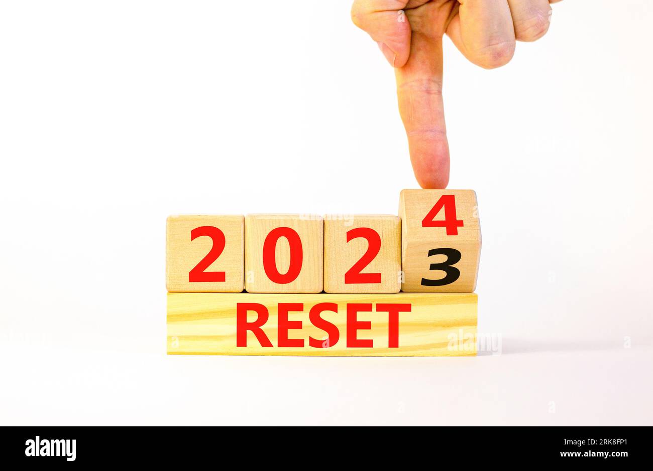 2024 reset new year symbol. Businessman turns a wooden cube and changes ...