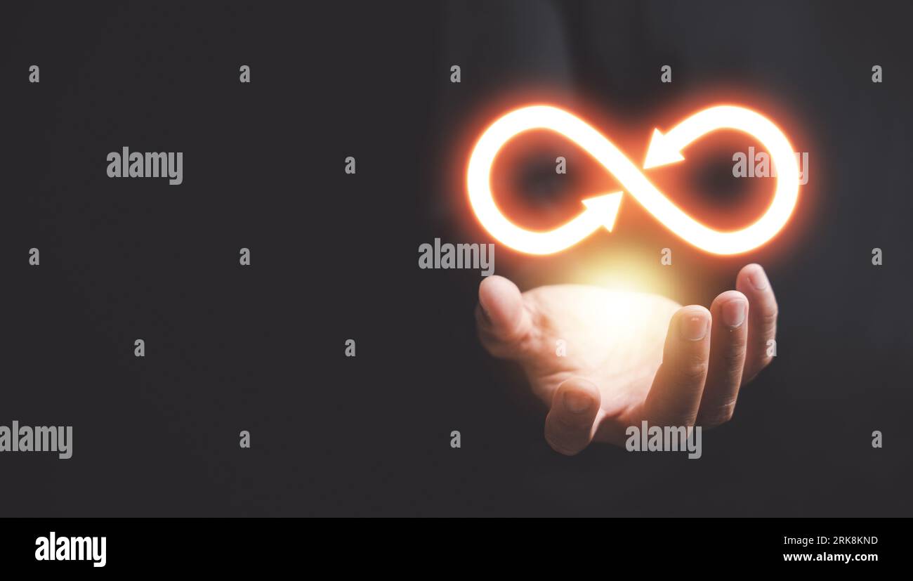 Circular infinity symbol in businessman's hand on dark background Stock ...