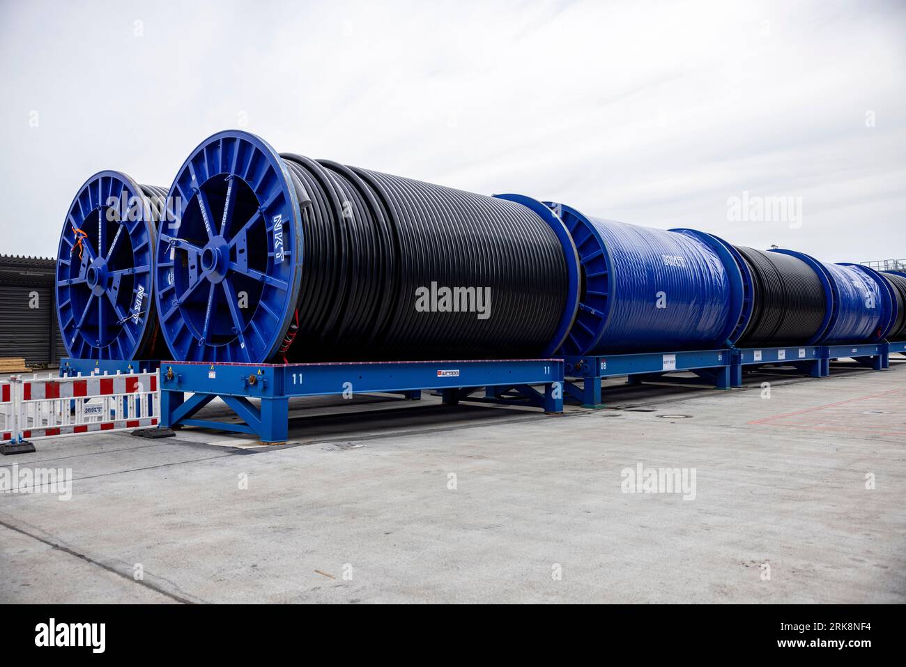Cologne, Germany. 24th Aug, 2023. Cable drums with coiled sheathed copper cable lie on a ...