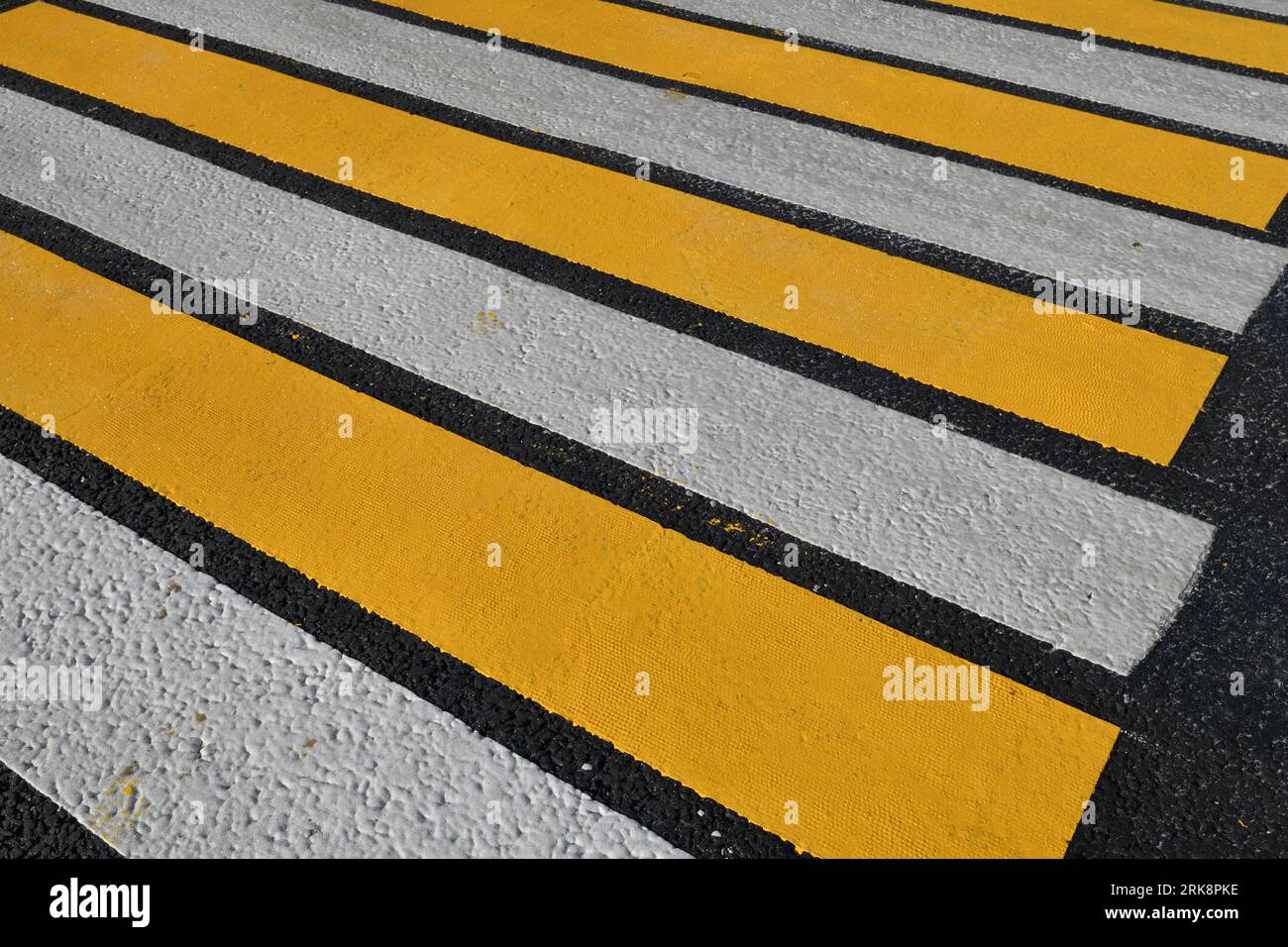 Yellow and white stripes on crosswalk Stock Photo - Alamy