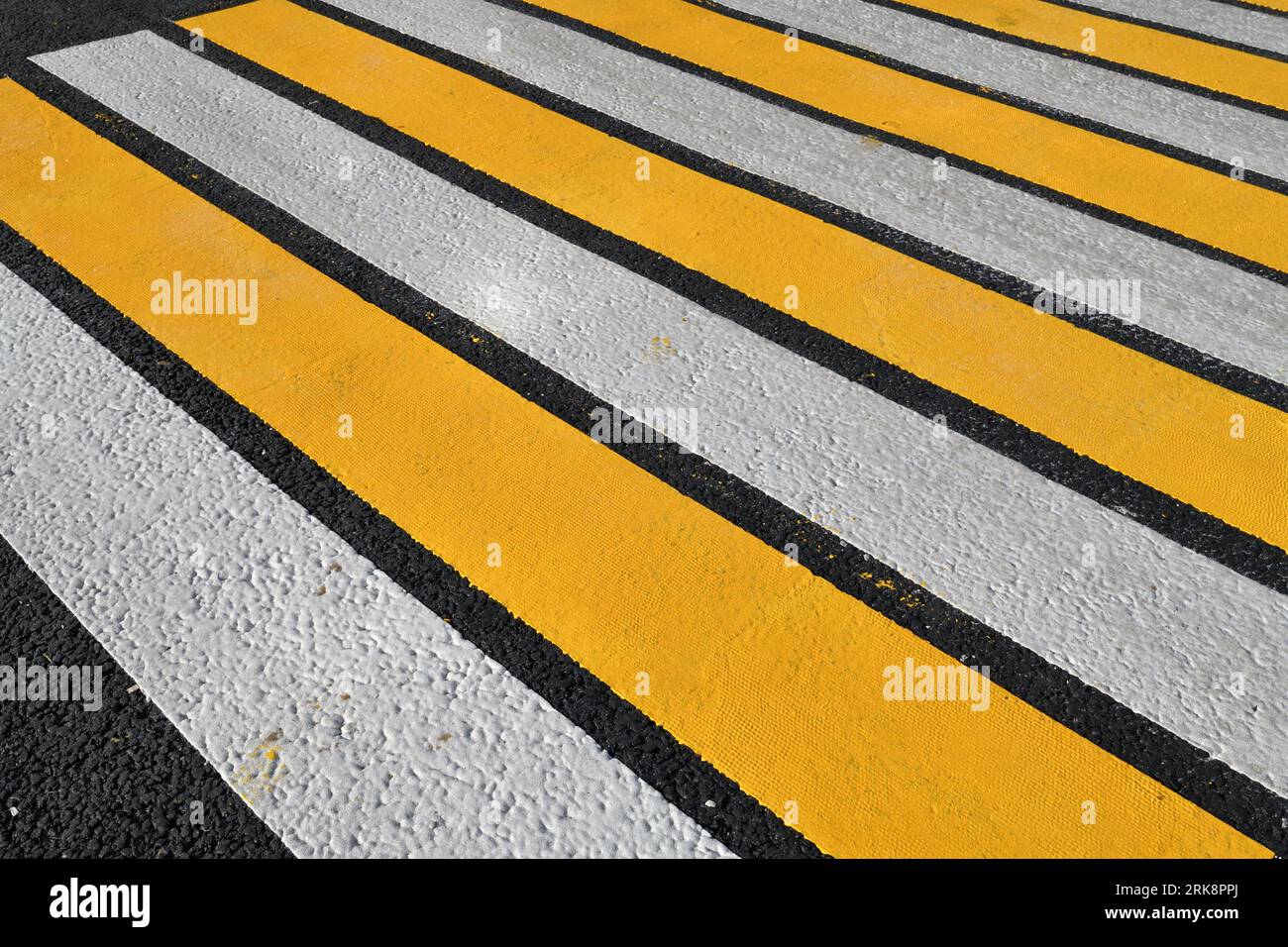 Yellow and white stripes on crosswalk Stock Photo - Alamy