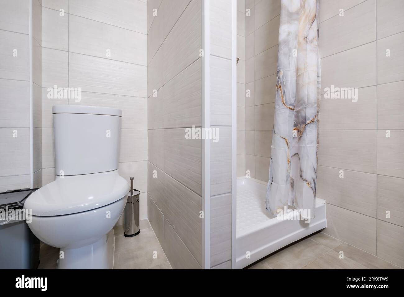 toilet and detail of a corner shower cabin with wall mount shower ...