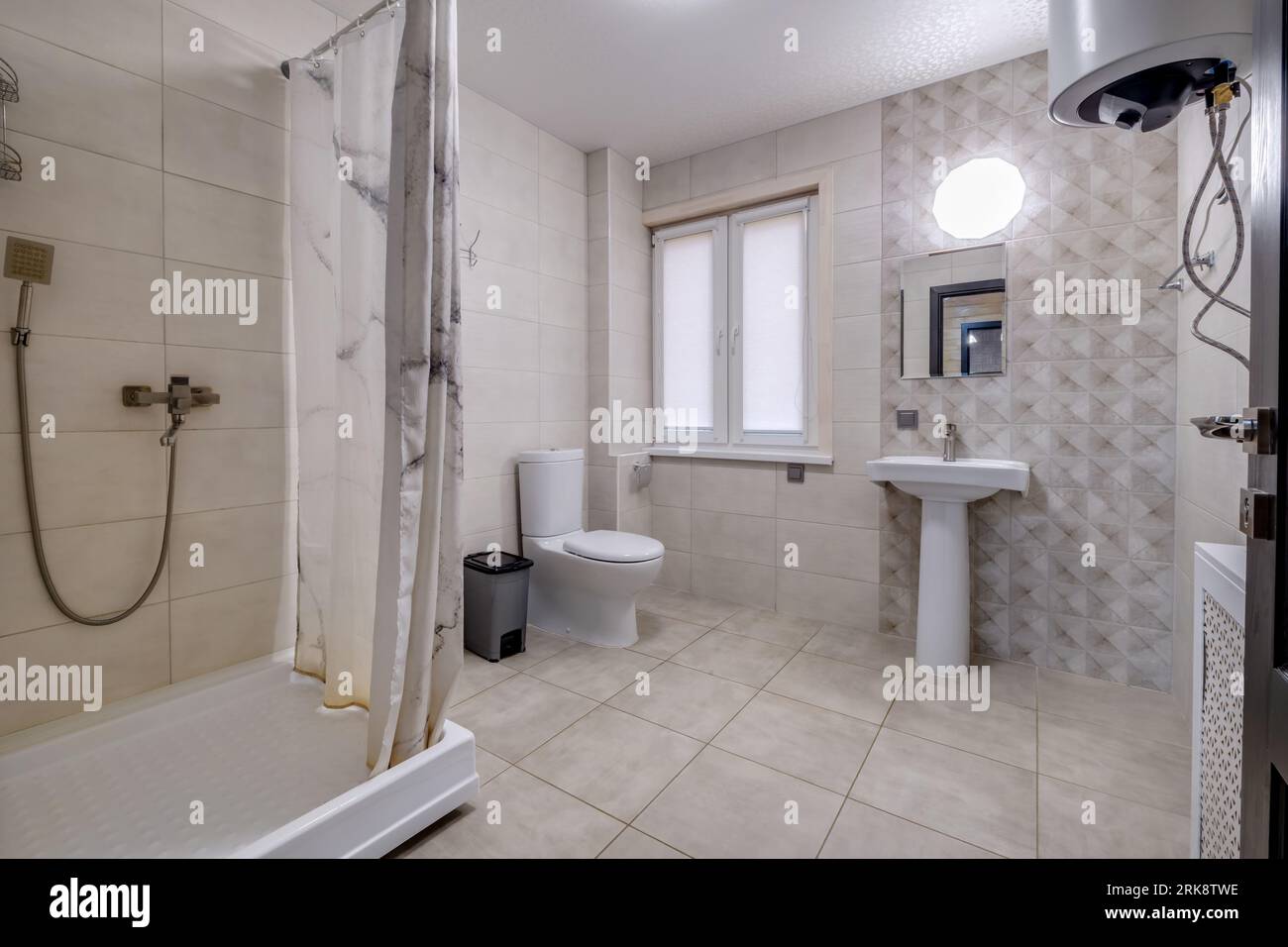 toilet and detail of a corner shower cabin with wall mount shower ...