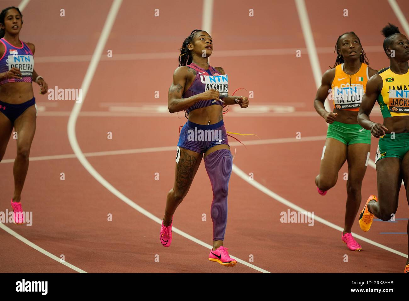 Sha'Carri Richardson, of the United States, centre, races to the finish ...