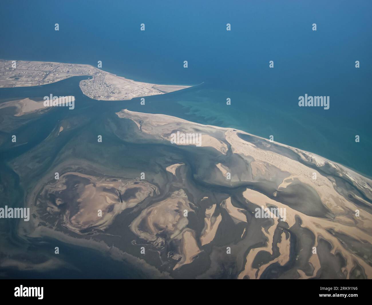 Persian Gulf seascape, rocky seabed is under blue shallow water ...