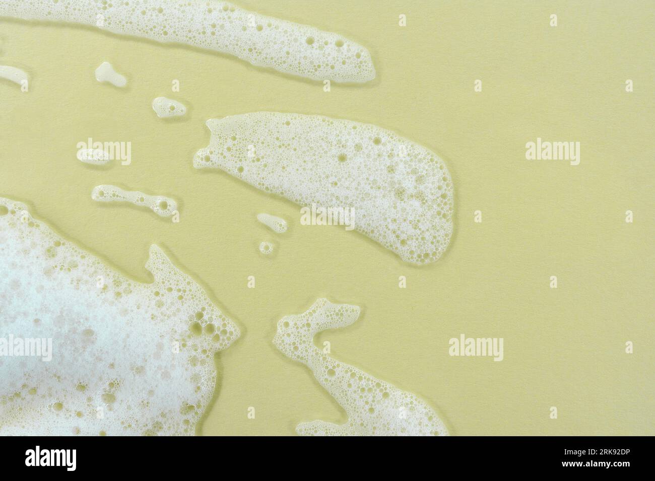 Foam swatch on a yellow background. Soapy liquid texture with bubbles ...