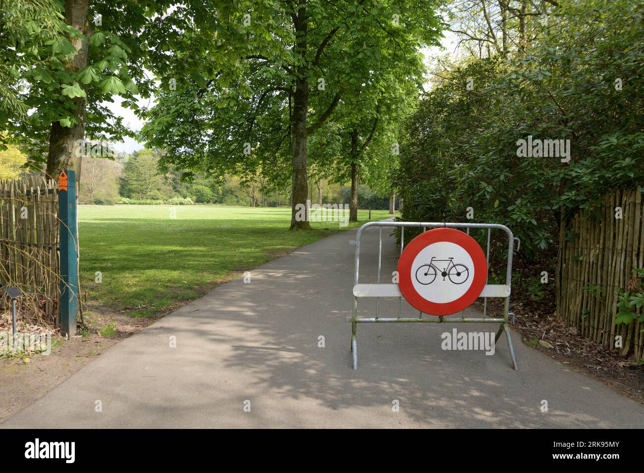 No bicycle - path only for walking. Portable fencing in a park with a ...