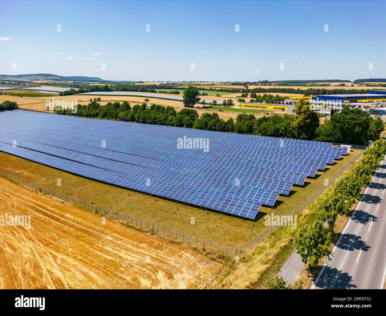 Solar farm with numerous rows of solar panels in a rural area in the ...
