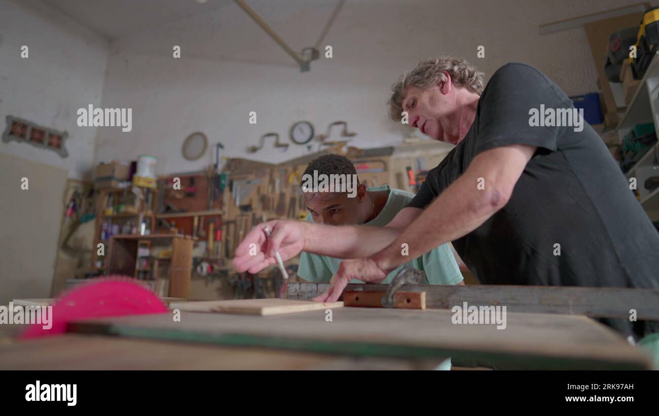 Master carpenter guiding student apprentice hi-res stock photography ...
