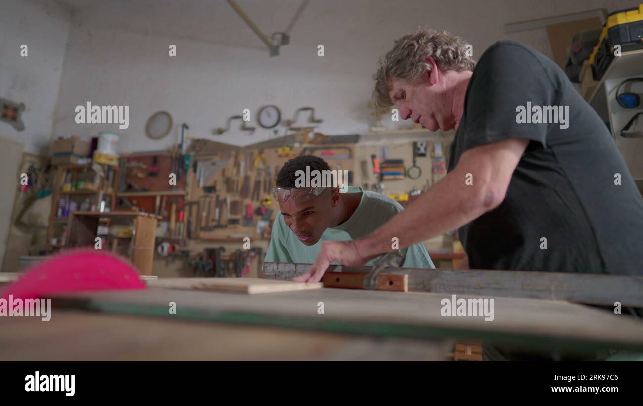 Master carpenter guiding student apprentice hi-res stock photography ...
