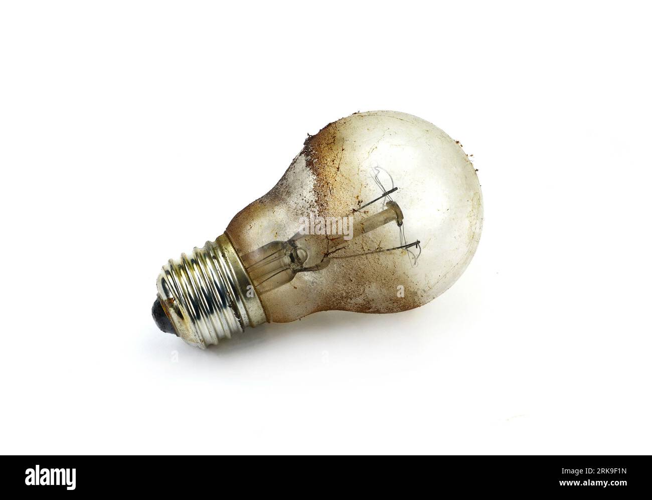 An old dirty light bulb isolated on white background Stock Photo - Alamy