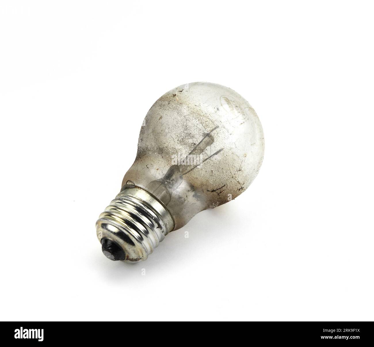 An old dirty light bulb isolated on white background Stock Photo - Alamy