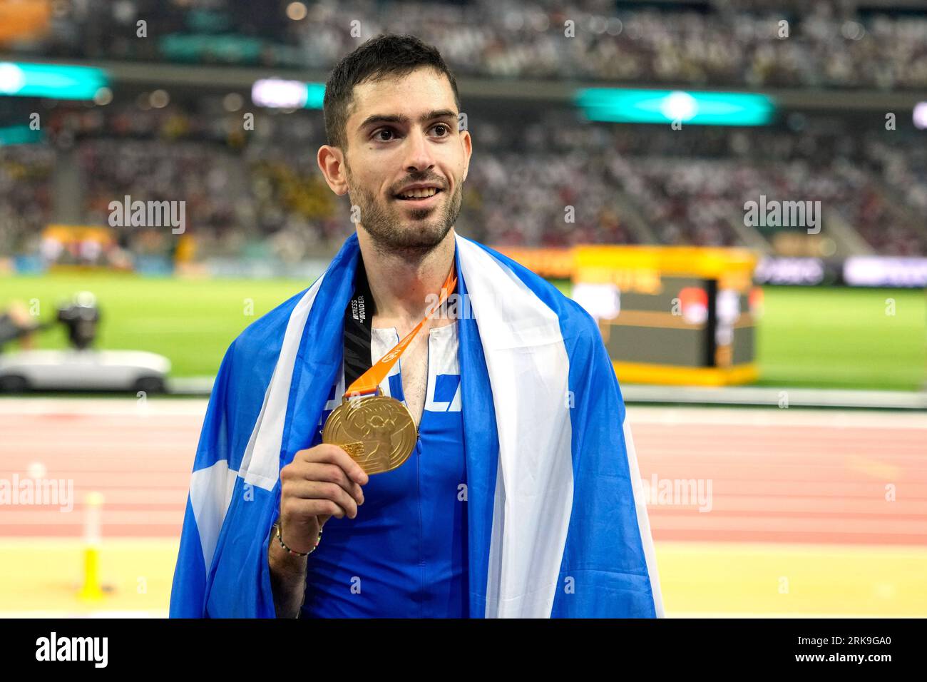 Miltiadis Tentoglou, of Greece, poses with his medal after winning the ... Miltiadis Tentoglou, of Greece, poses with his medal after winning the ...