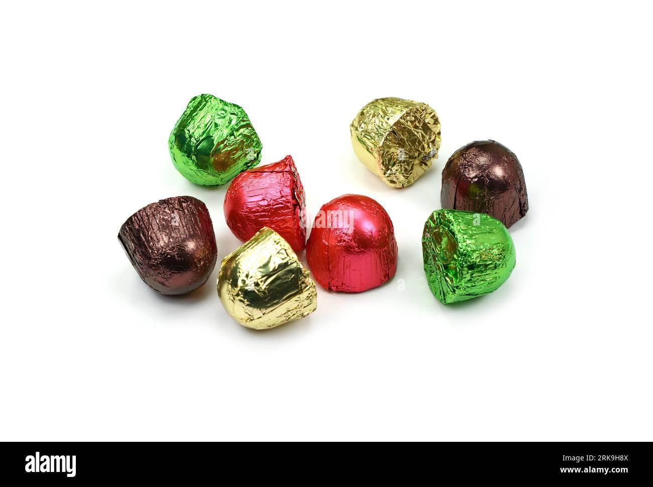Chocolates in a multi-colored foil isolated on white background Stock ...