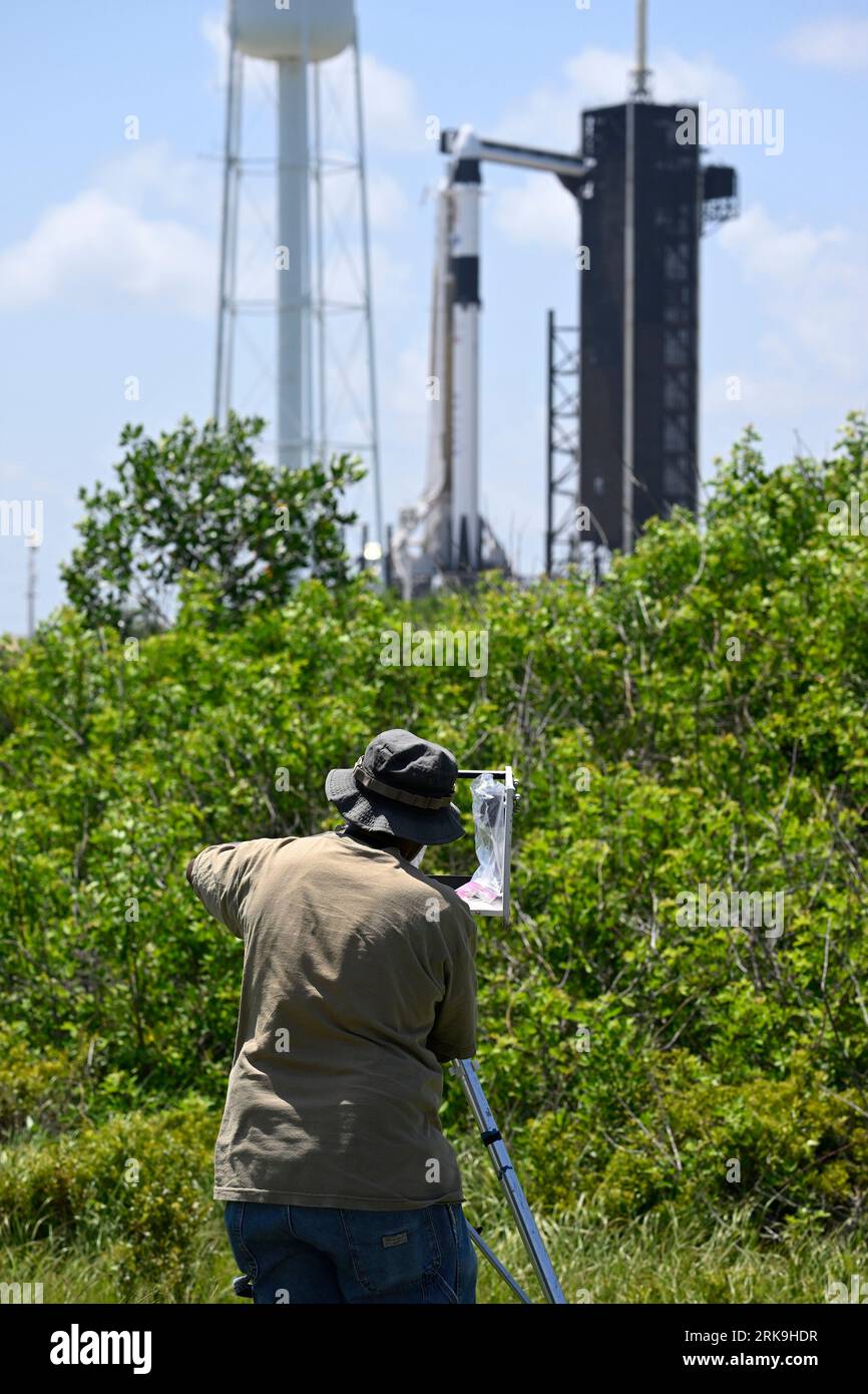 A media photographer sets up his remote cameras to capture the launch ...