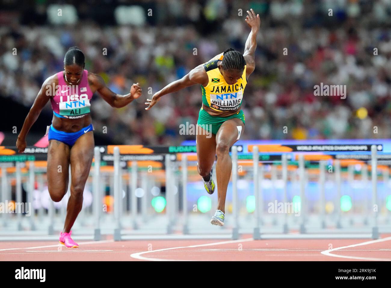 Danielle Williams, of Jamaica, right, crosses the line to win the gold ...