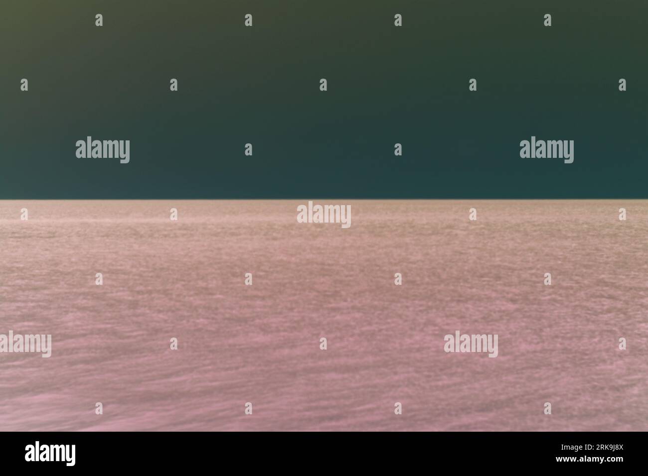 A very simple minimal view of the ocean and sky and horizon line in a ...