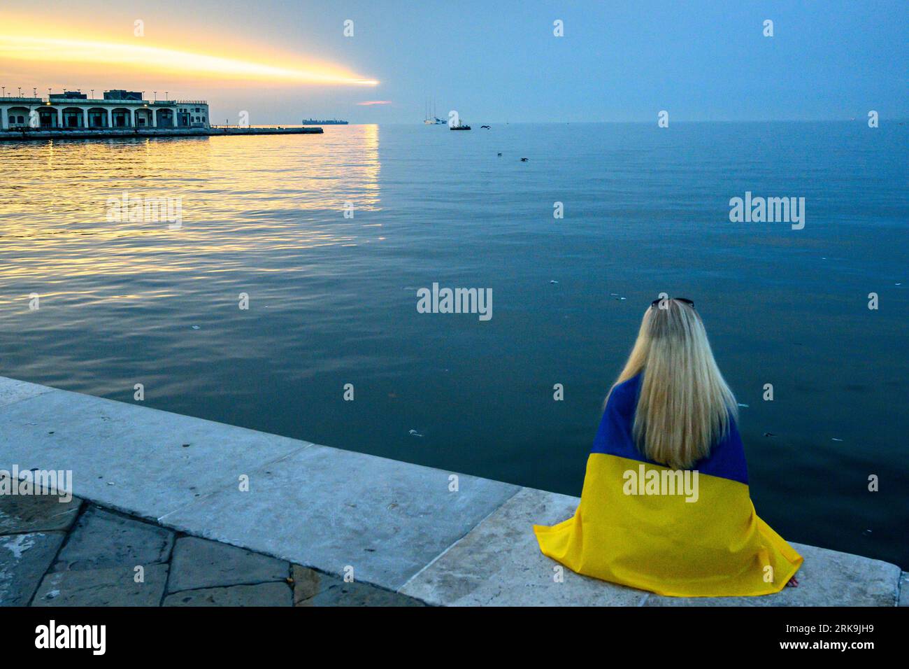 Trieste, Italy, 24 August 2023. An Ukrainian woman watches the sunset ...