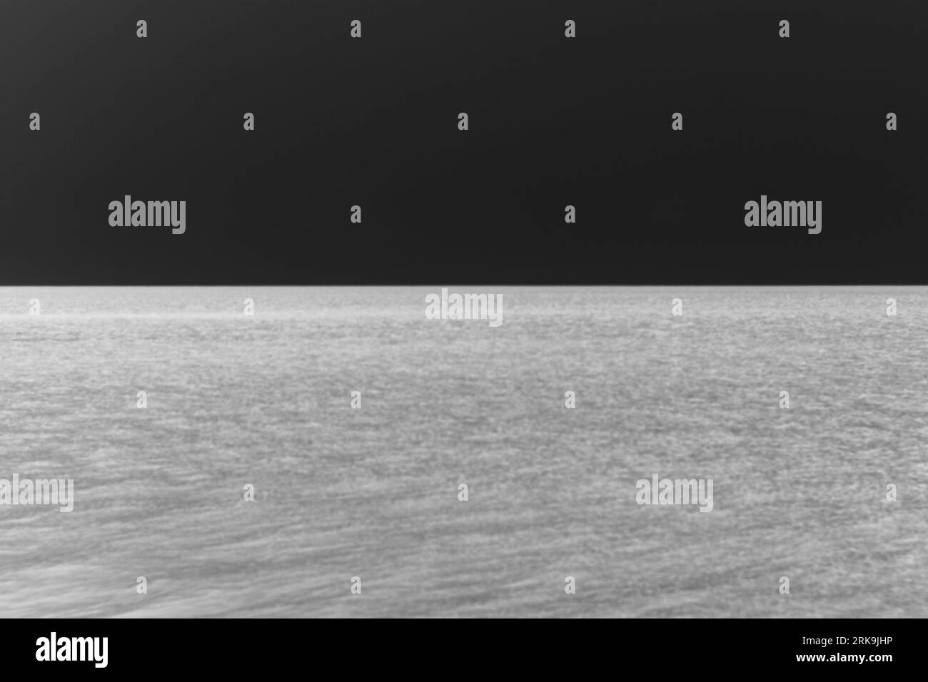 A very simple minimal view of the ocean and sky and horizon line in a ...