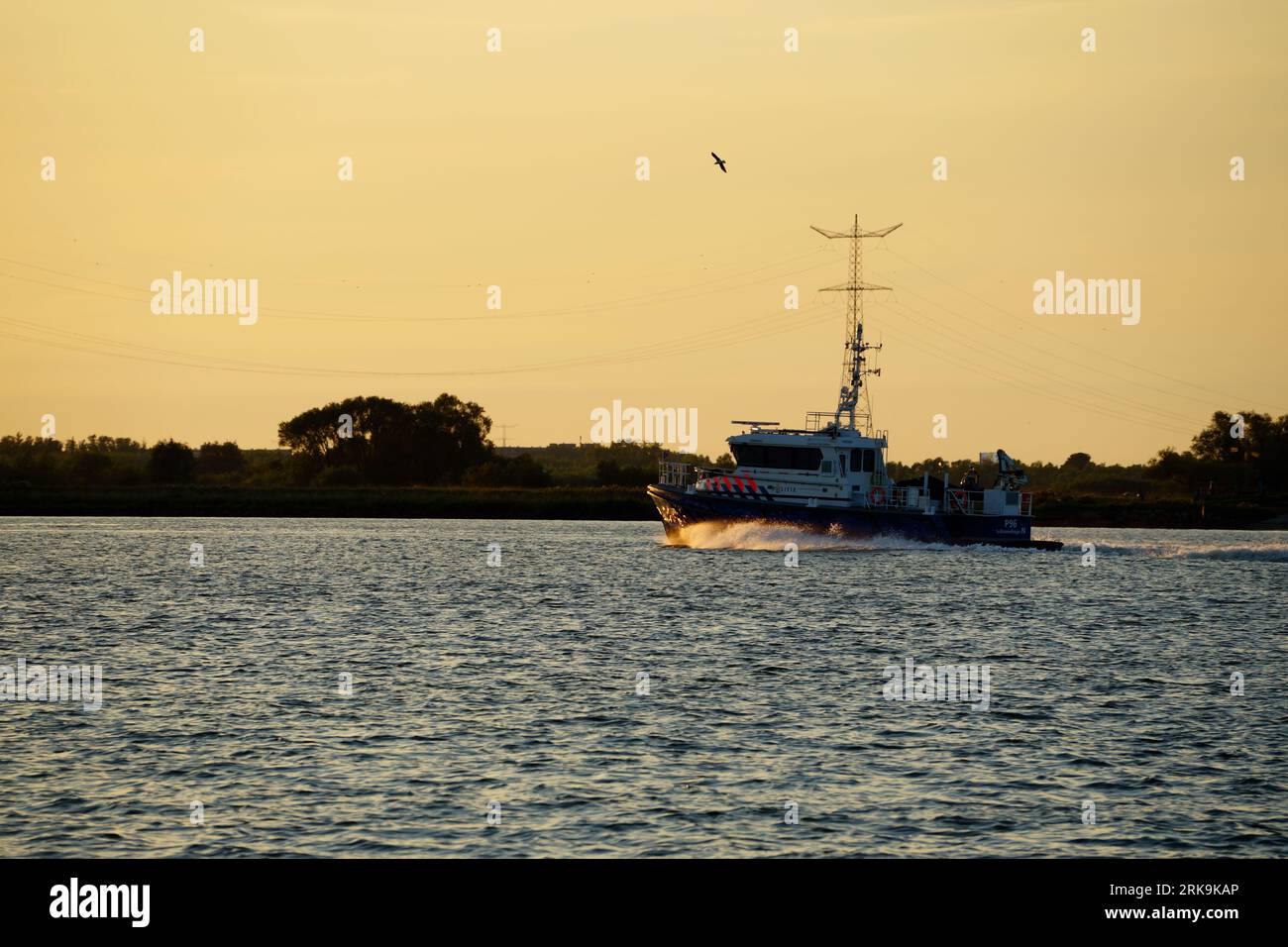Dutch Police Boat On River During Sunset Stock Photo - Alamy
