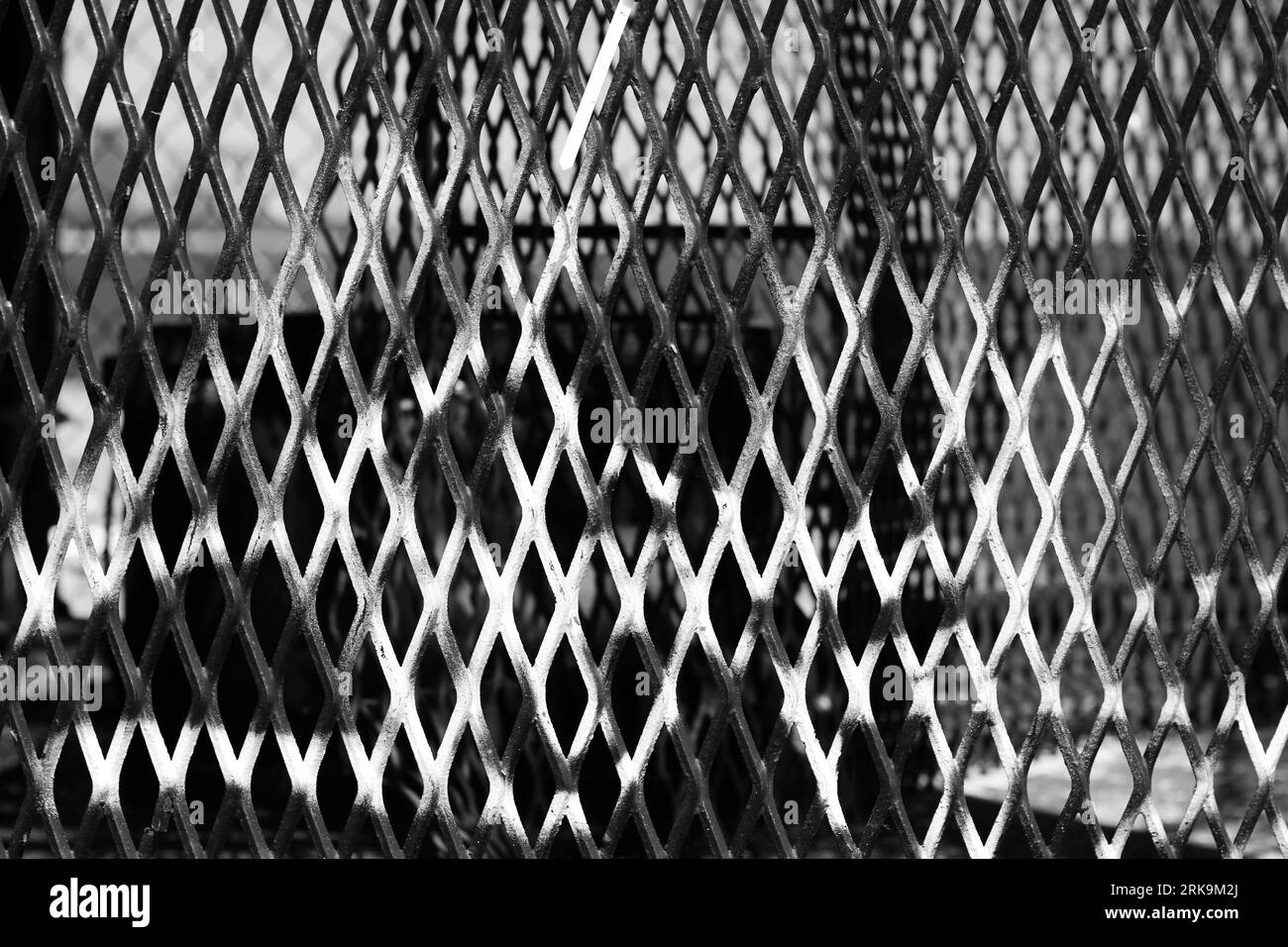 A common industrial chain link metal fence with a repeating pattern in ...
