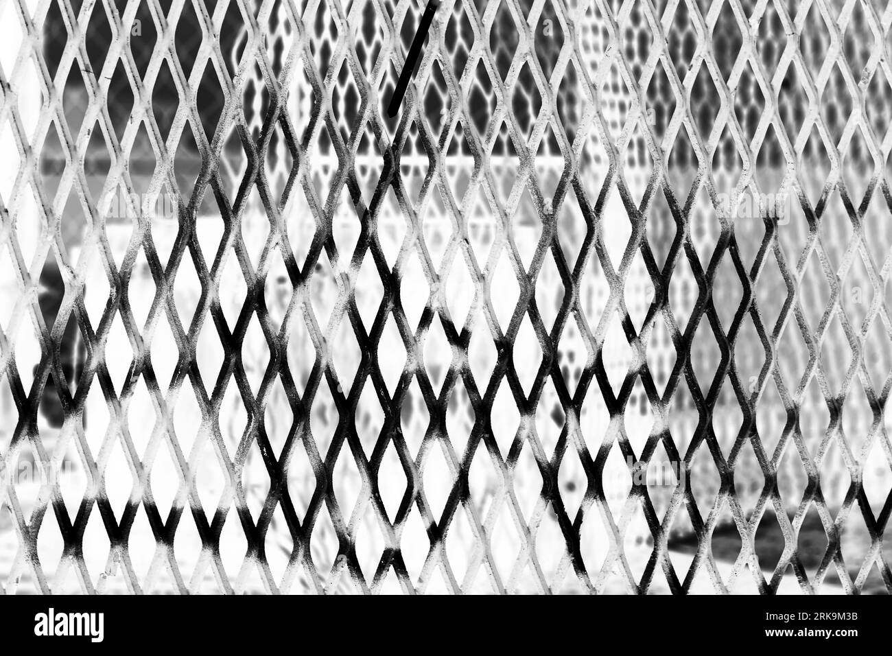 A common industrial chain link metal fence with a repeating pattern in ...