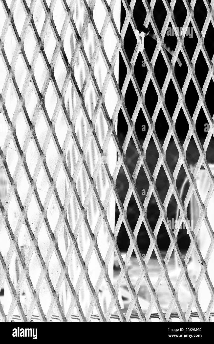 A typical metal chain link fence with a repeating pattern of steel ...