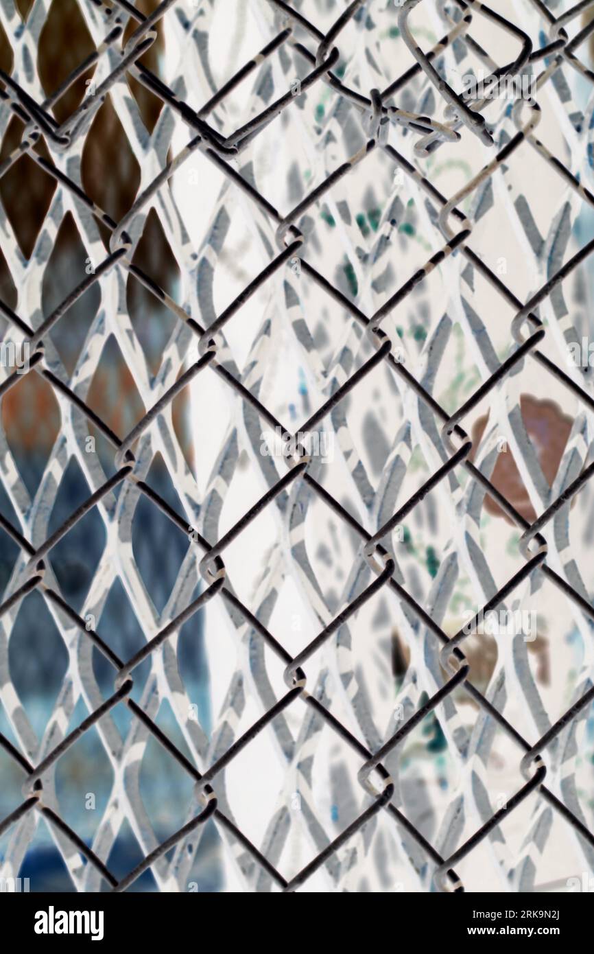 A typical metal chain link fence with a repeating pattern of steel ...