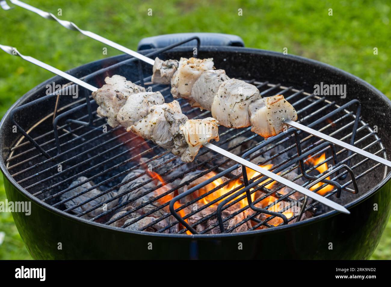 marinated pork skewers grilling on charcoal grill Stock Photo - Alamy
