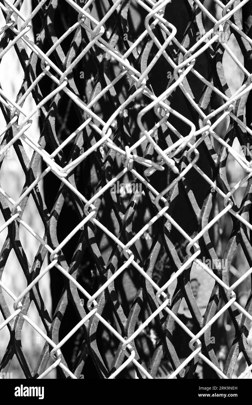 A typical metal chain link fence with a repeating pattern of steel ...