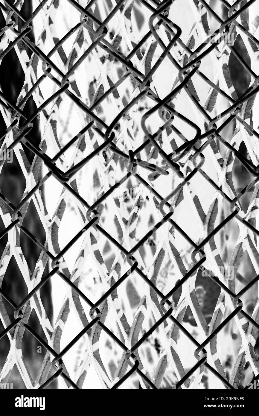 A typical metal chain link fence with a repeating pattern of steel ...