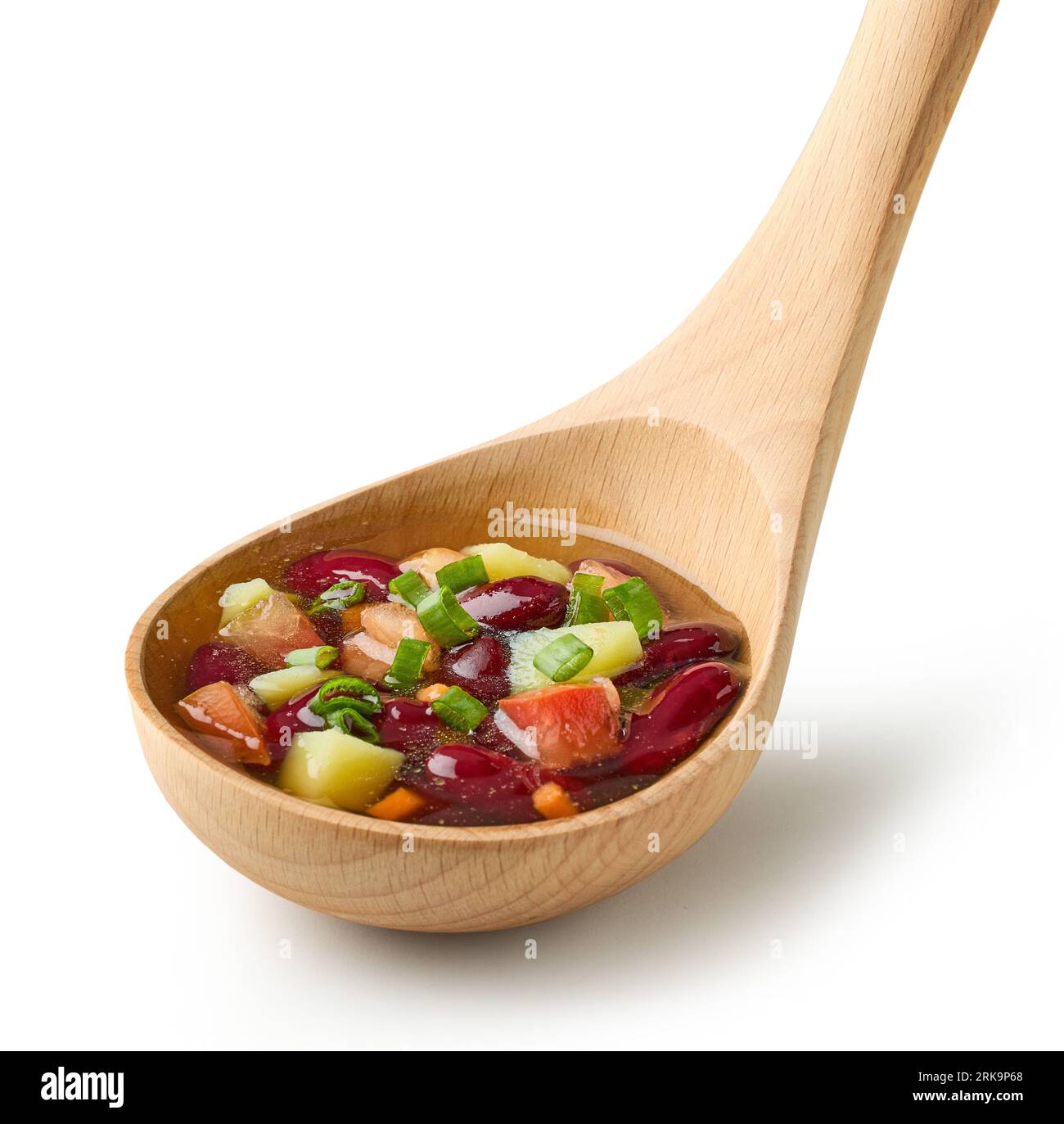 vegetable soup in wooden ladle isolated on white background Stock Photo ...
