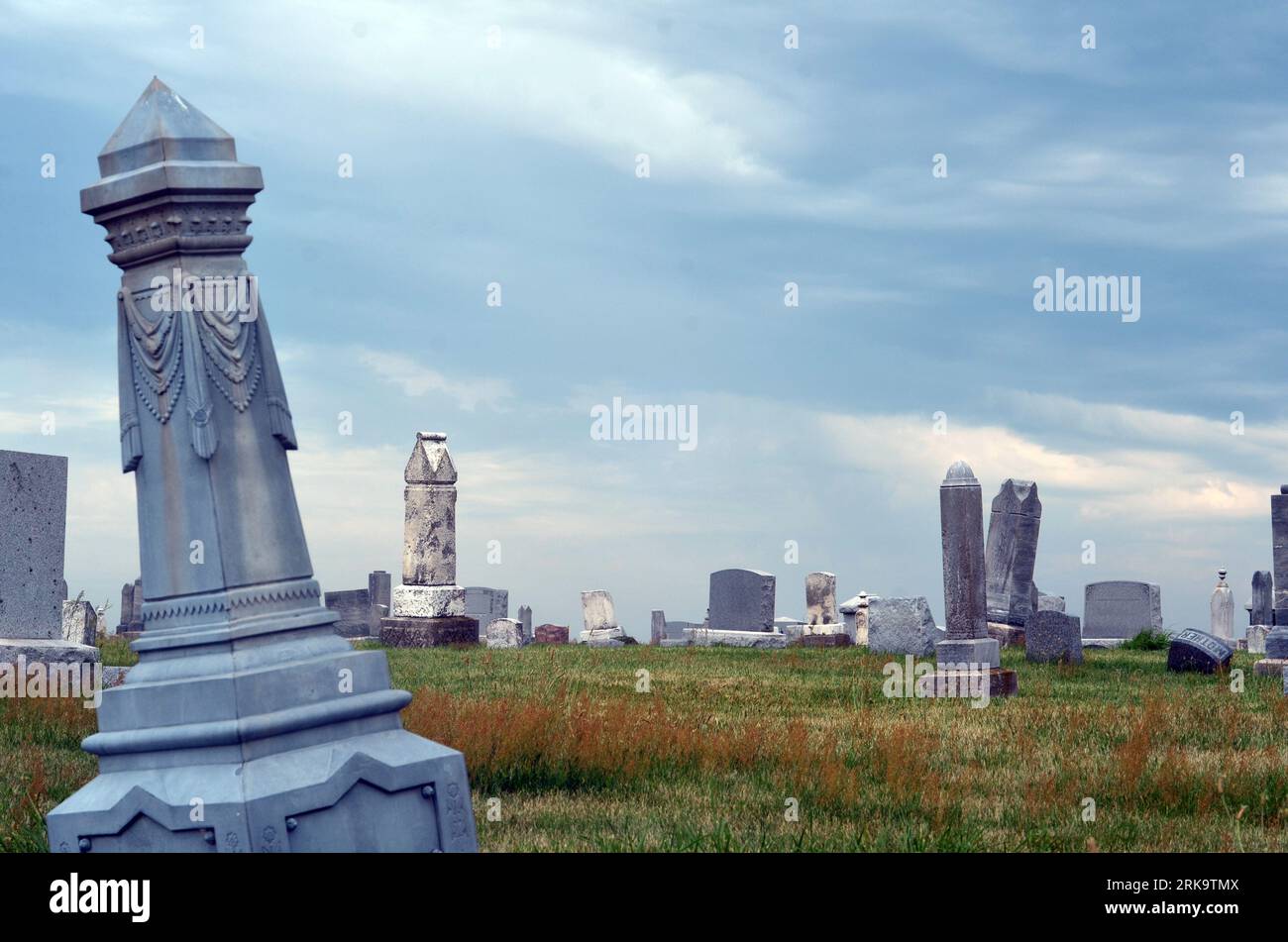 graveyard monuments with rain in the distance Stock Photo - Alamy