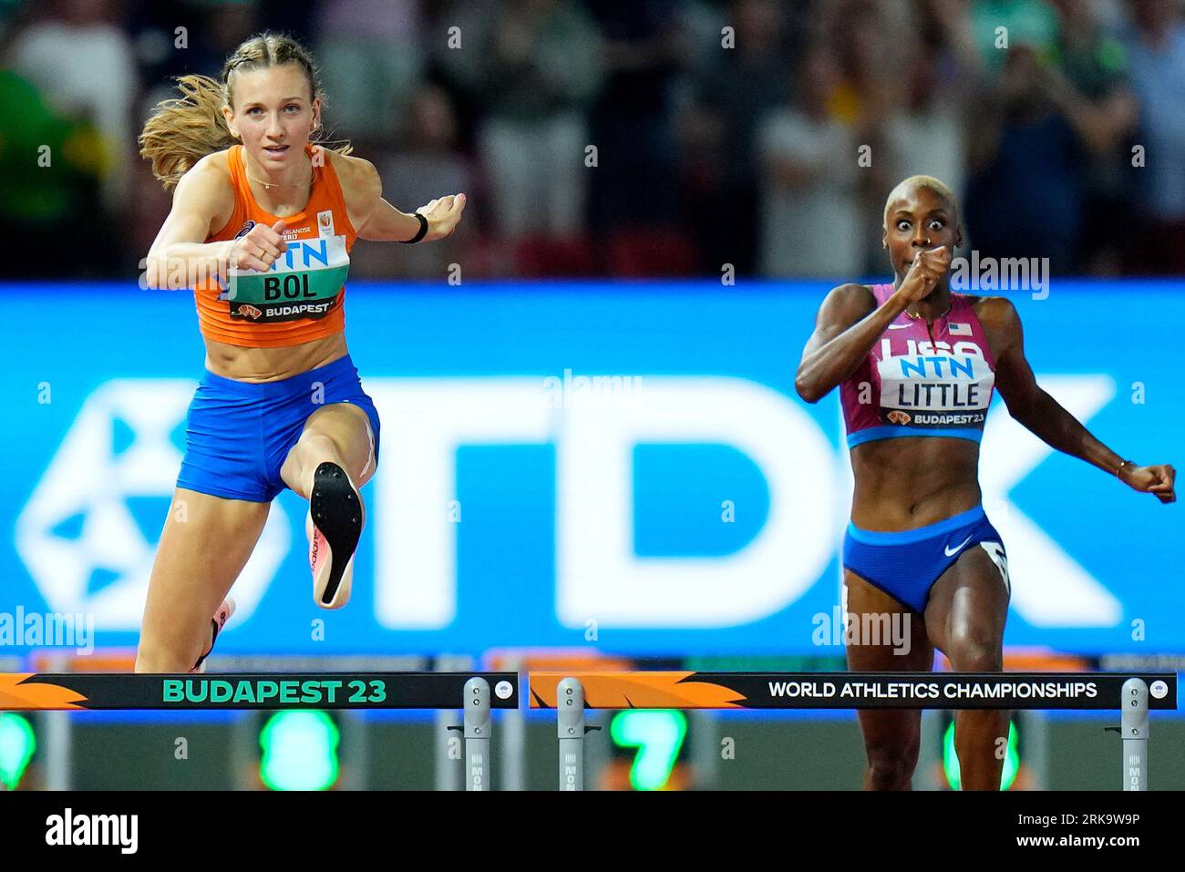 Femke Bol, of the Netherlands, center, races ahead of Shamier Little ...
