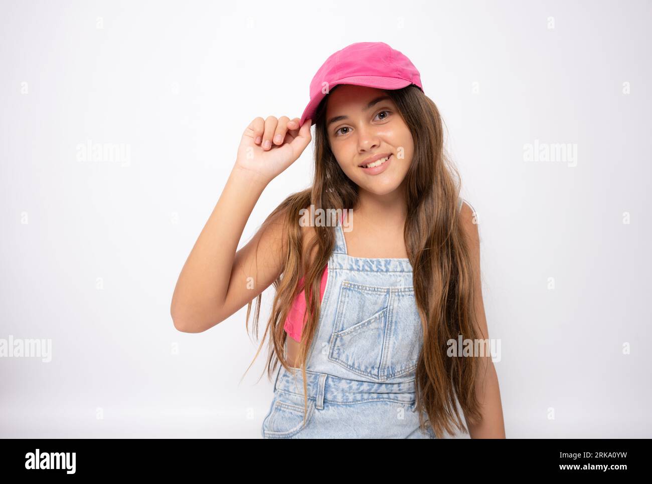 Little girl wearing a pink cap on a white background Stock Photo - Alamy