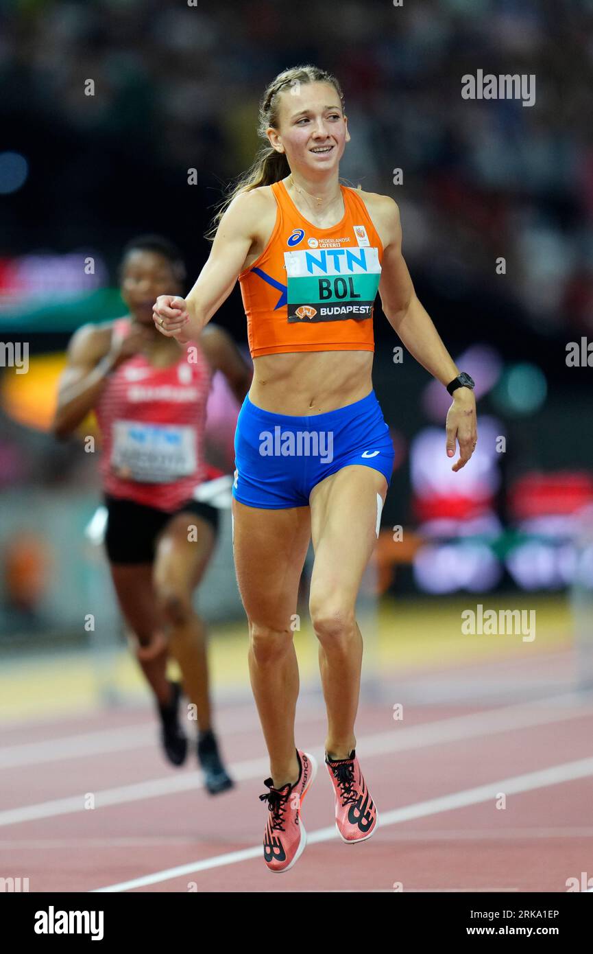 Femke Bol, of the Netherlands, center, crosses the line to win the gold ...