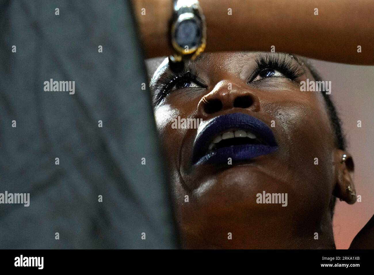 Rushell Clayton, of Jamaica, holds up the flag of her country after ...