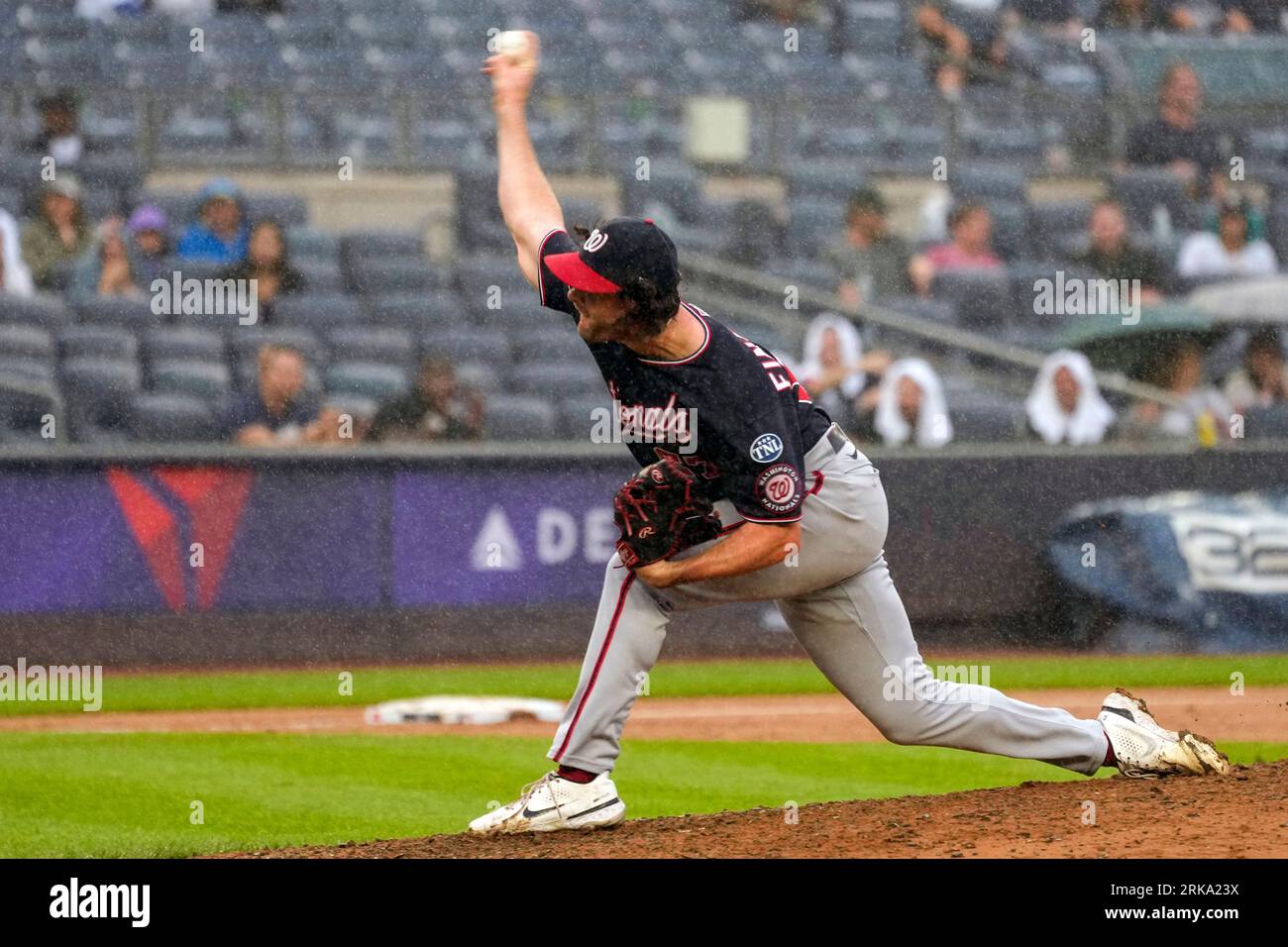 Washington Nationals relief pitcher Kyle Finnegan delivers in the rain ...