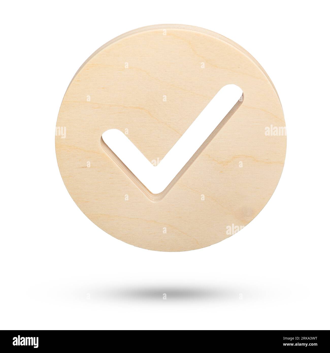 Check mark symbol on white isolated background. A large wooden round ...