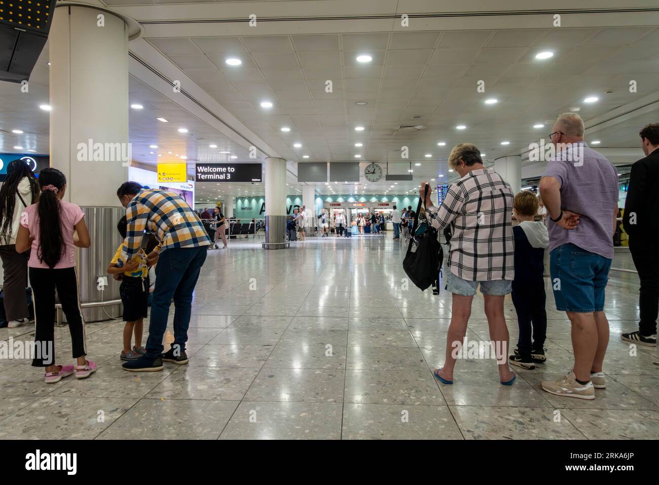 People stand and wait for loved ones at arrivals at London Heathrow ...