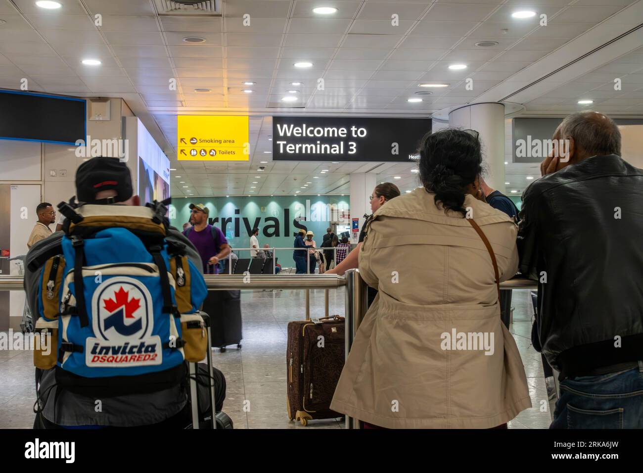 People stand and wait for loved ones at arrivals at London Heathrow ...